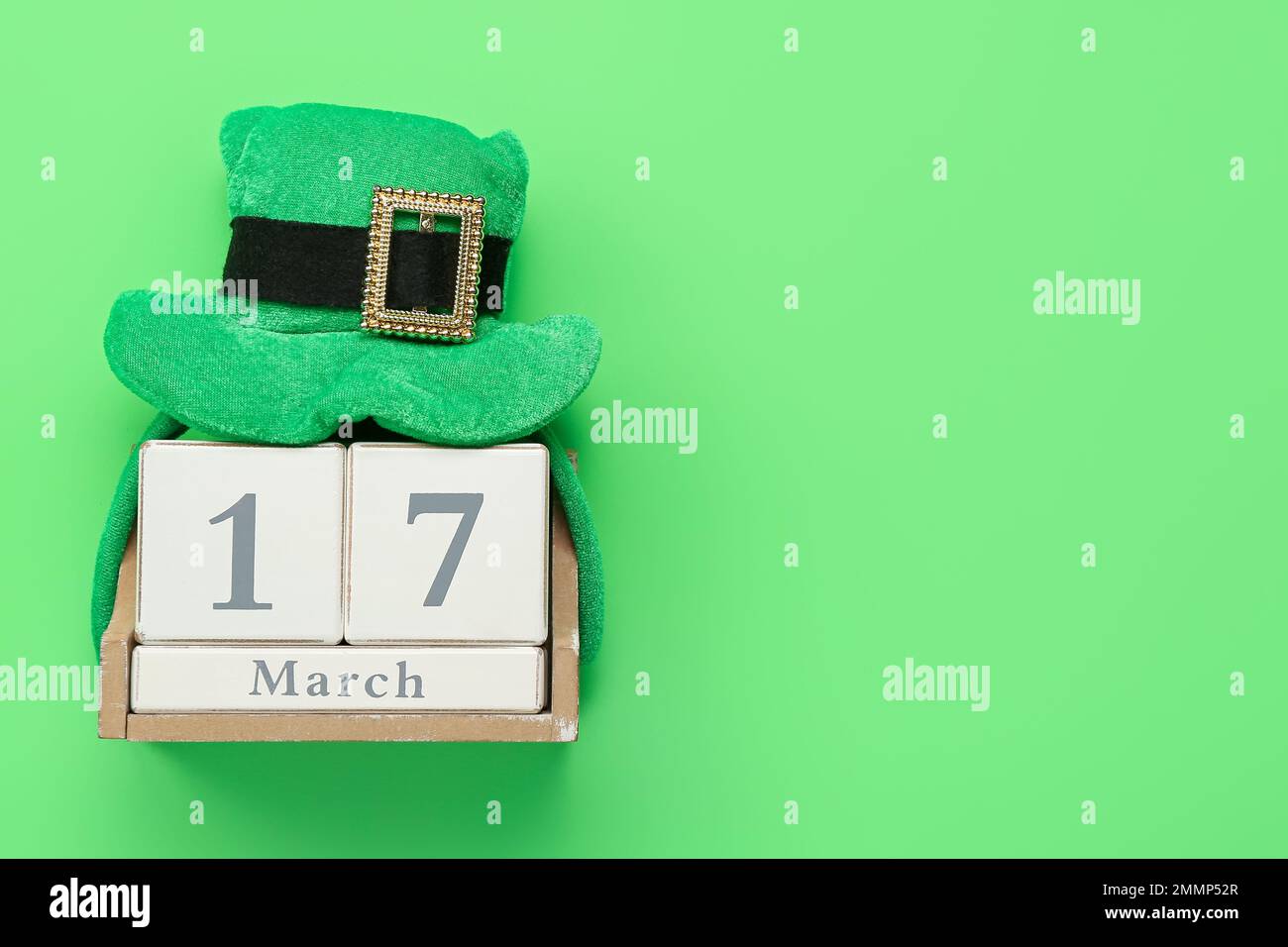 Leprechaun hat and calendar with date of St. Patrick's Day on green ...