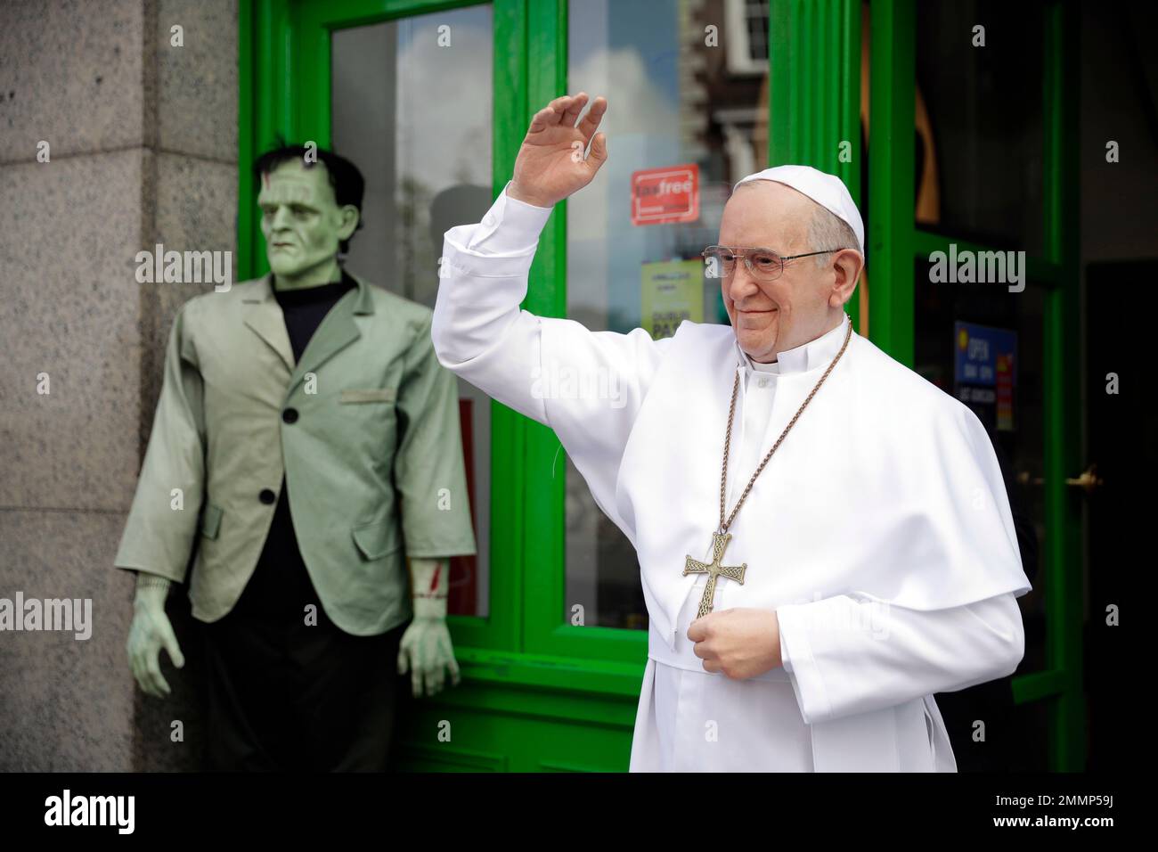 A recently unveiled waxwork statue of Pope Francis is displayed next to ...