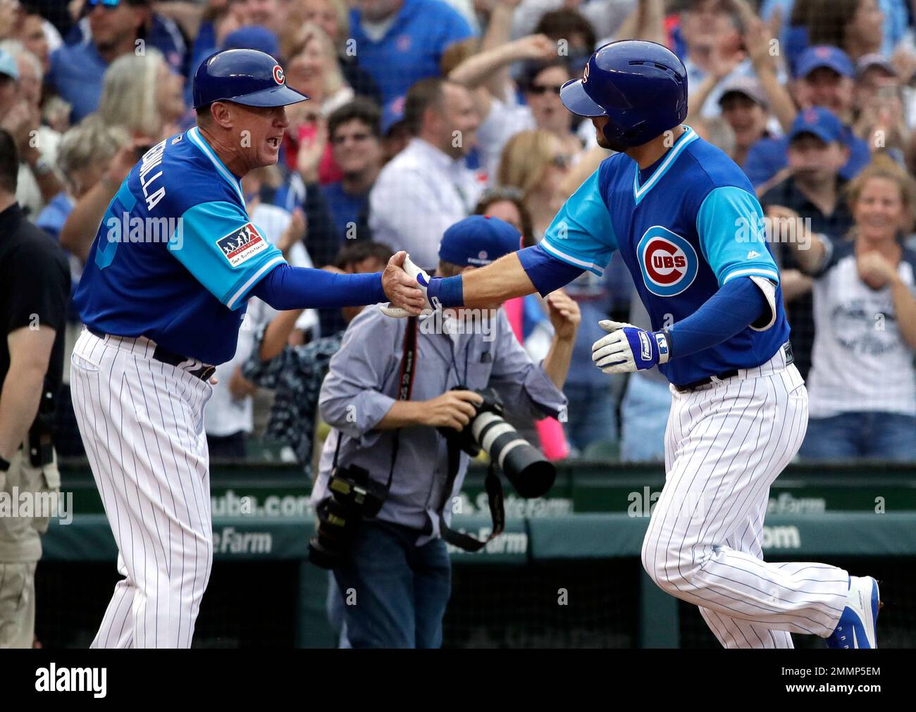 Chicago Cubs' David Bote, right, celebrates with third base coach Brian ...
