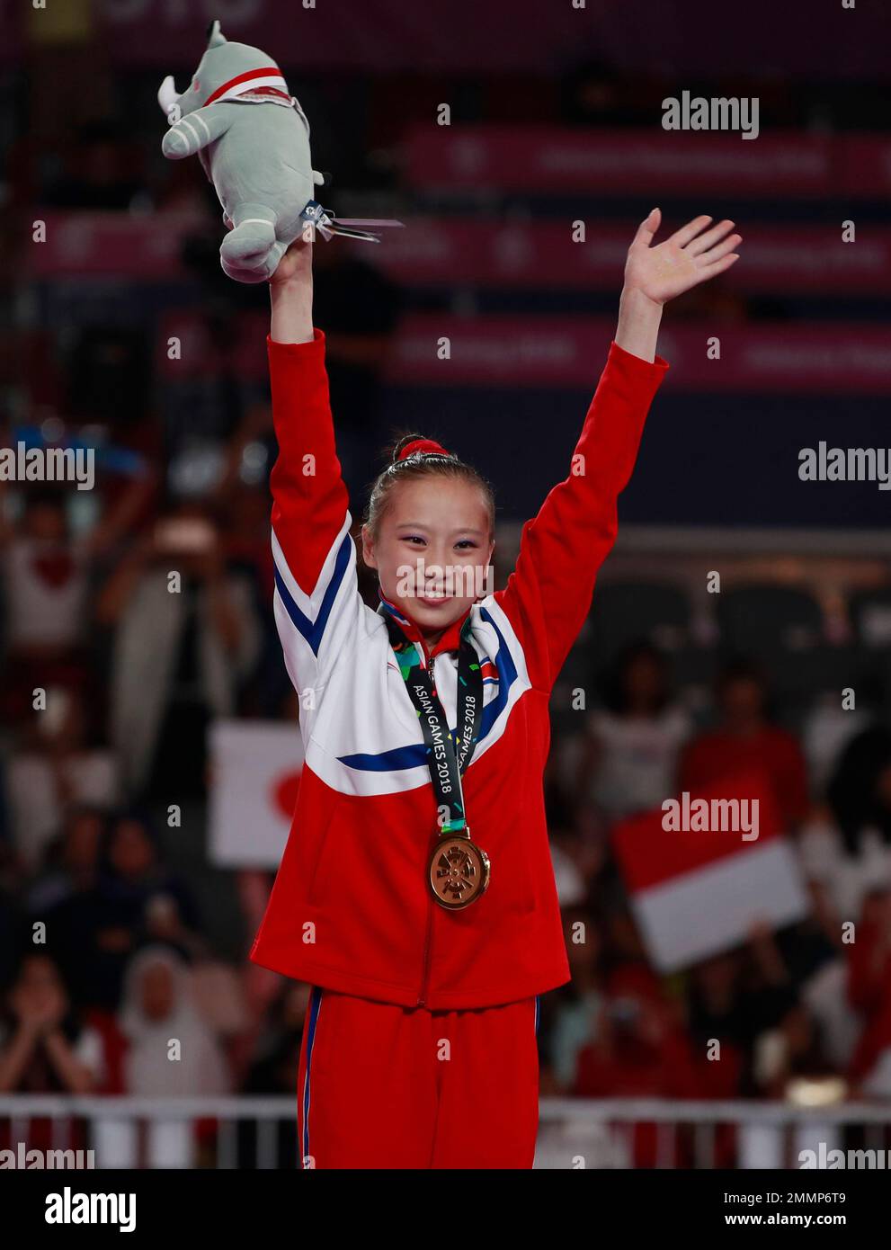 Gold medalist Kim Su Jong of North Korea celebrates on the podium ...