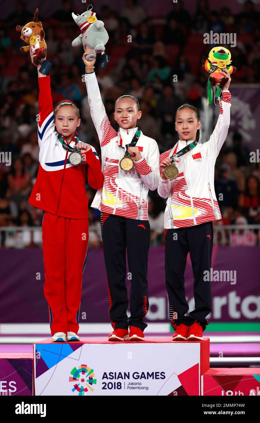 Balance beam gold medalist China's Chen Yile, centre, stands with ...