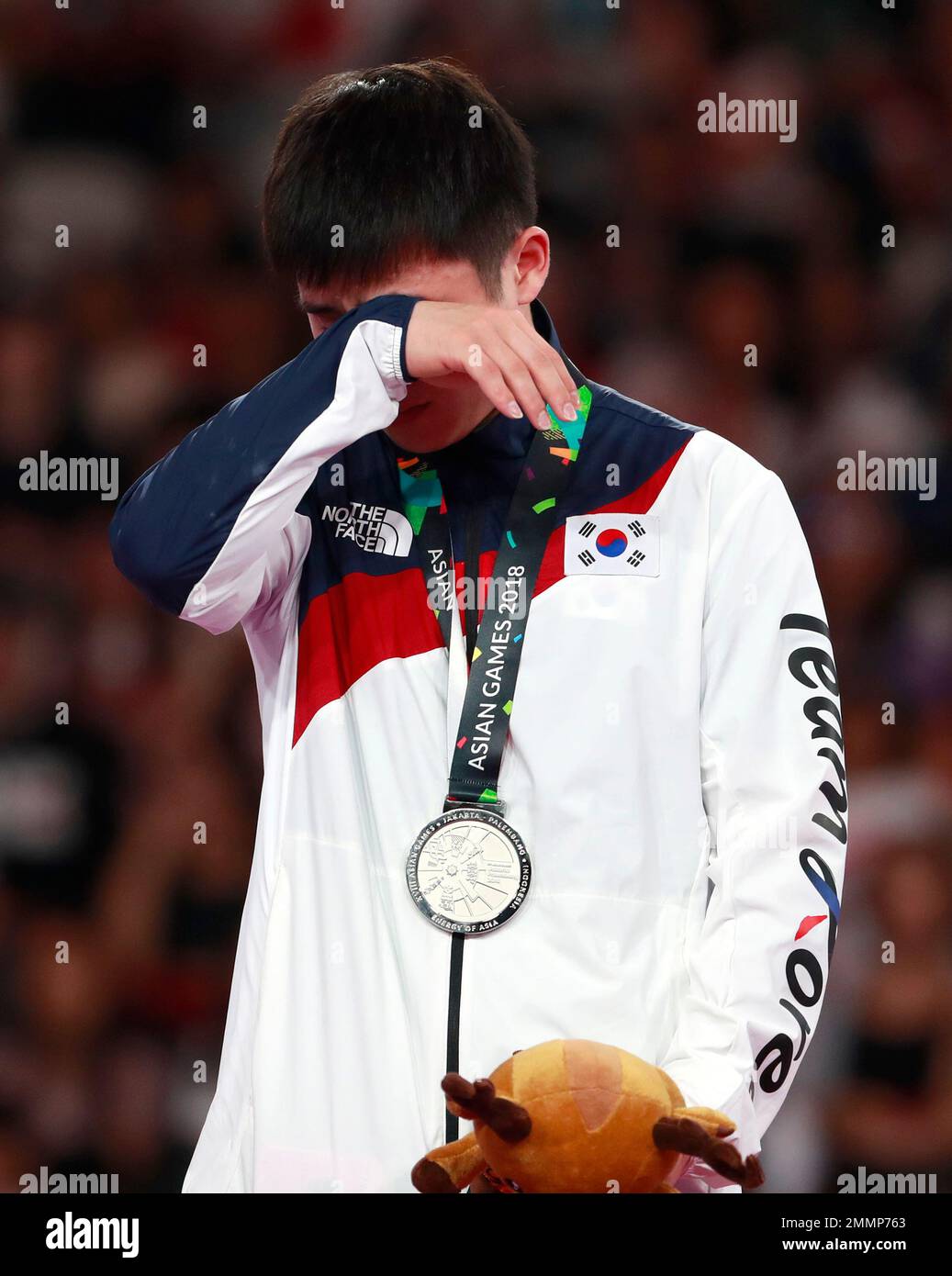 South Korea's Kim Han-sol wipes tears from his eyes after receiving his ...