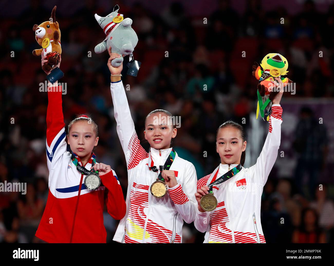 Balance beam gold medalist China's Chen Yile, centre, stands with ...