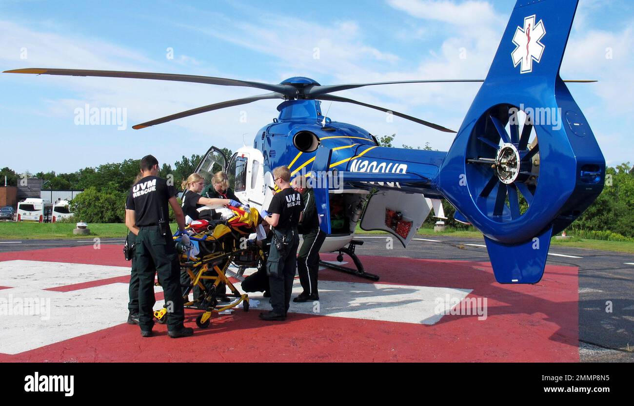 Emergency workers off load a patient from a helicopter at the ...