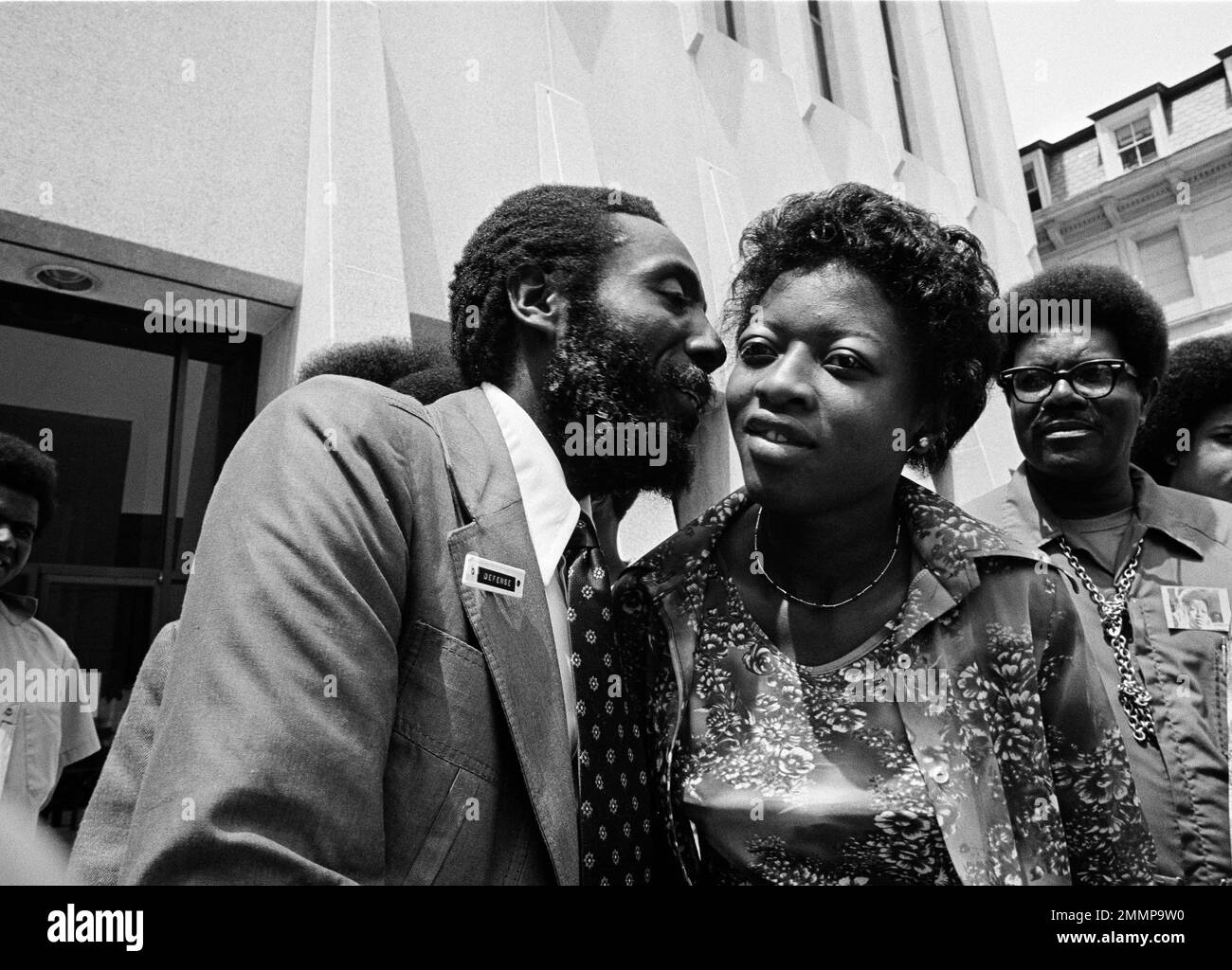 Civil rights activist and comedian Dick Gregory plants a kiss on Joan ...