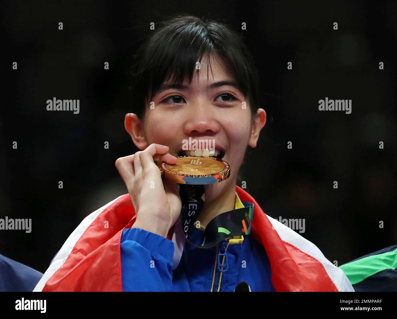 Panipak Wongpattanakit of Thailand bites her gold medal at the women's ...