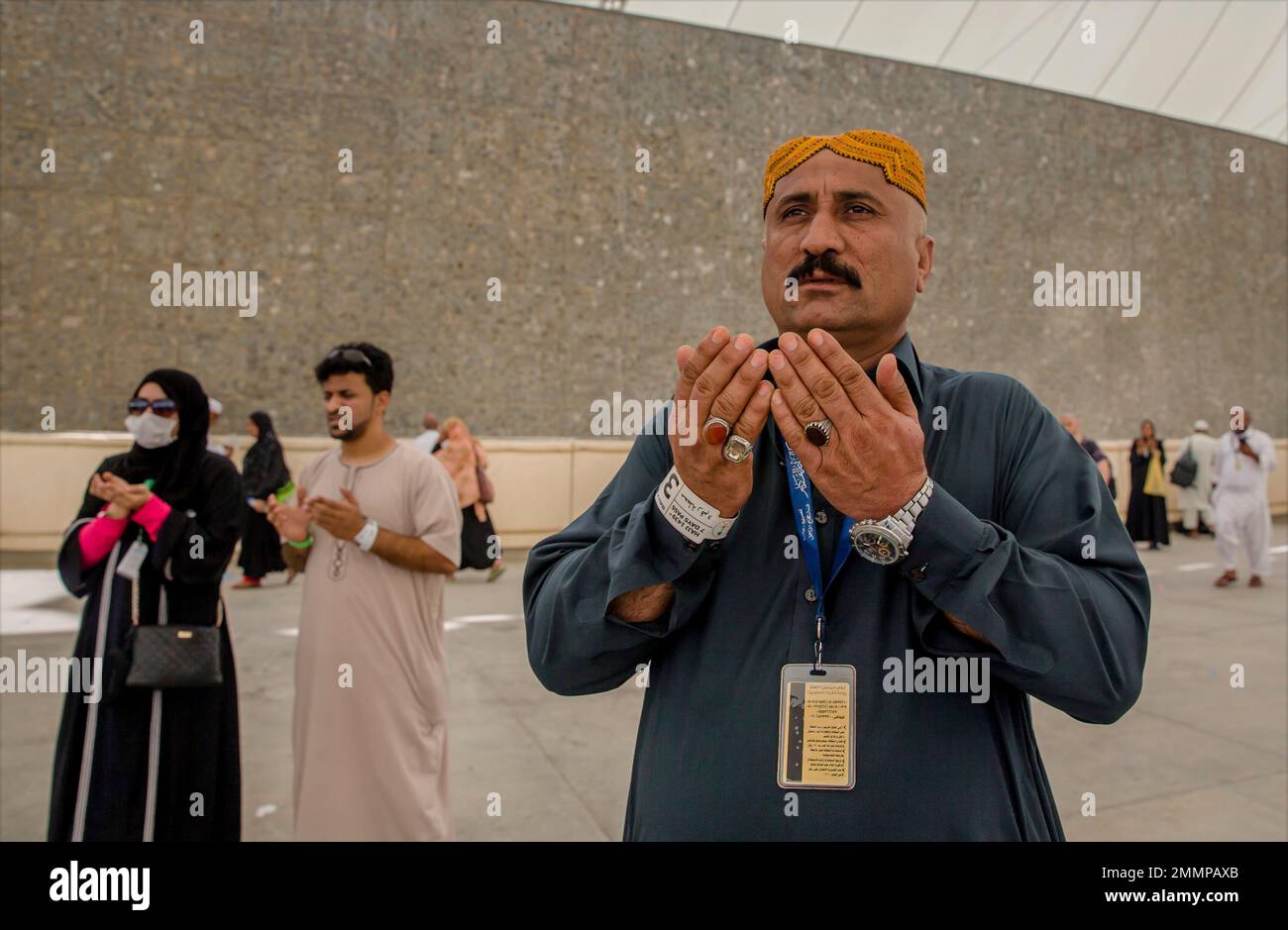 Muslim pilgrims pray after casting stones at three huge stone pillars ...