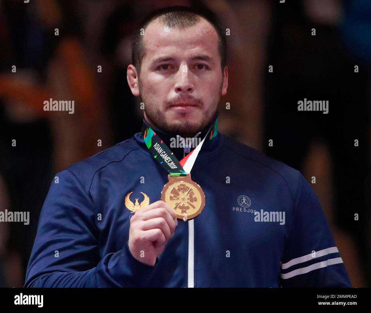 Gold medals Uzbekistan's Muminjon Abdullaev poses to photographer during ceremonies for their ...
