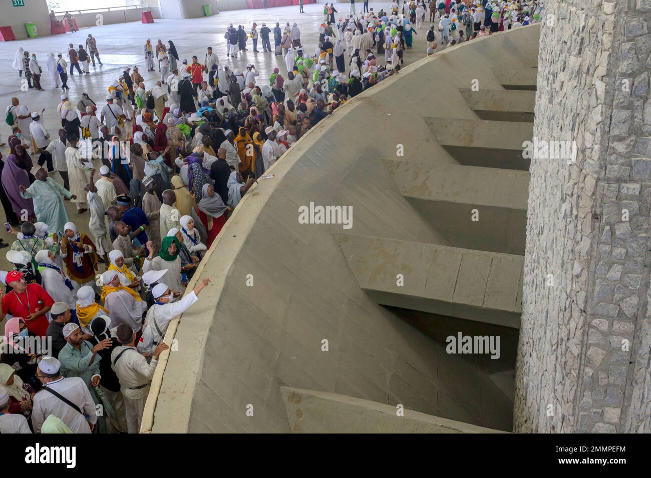 Muslim pilgrims cast stones at three huge stone pillars in the symbolic ...