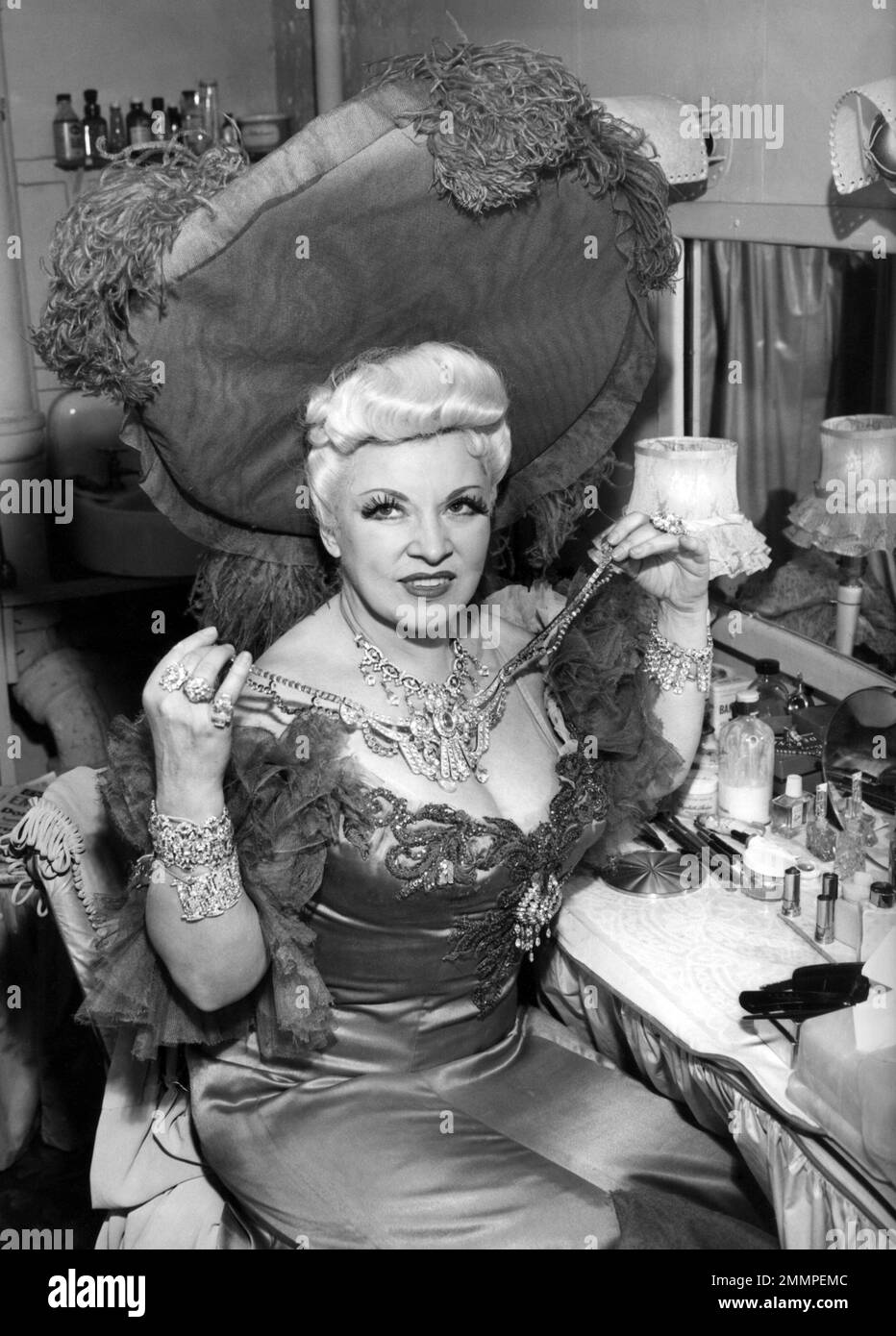 Just before curtain call, Mae West puts on the "prop" diamonds which she wears in Diamond Lil ...