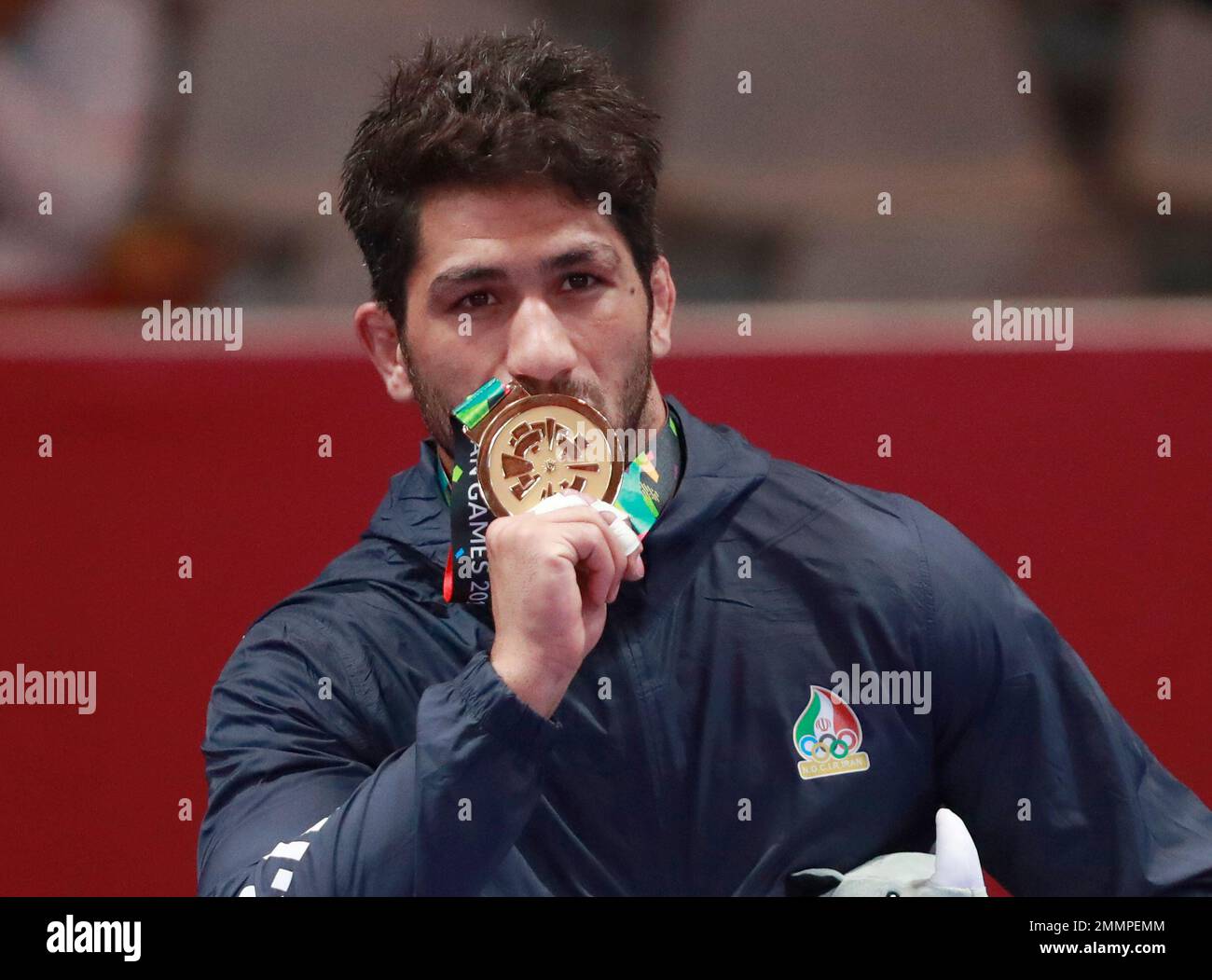 Gold medals Iran's Hassein Noury poses to photographer during ...