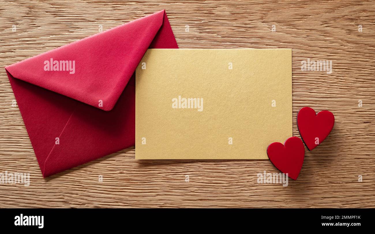Gold paper love letter copy space with red envelope on wooden desk ...