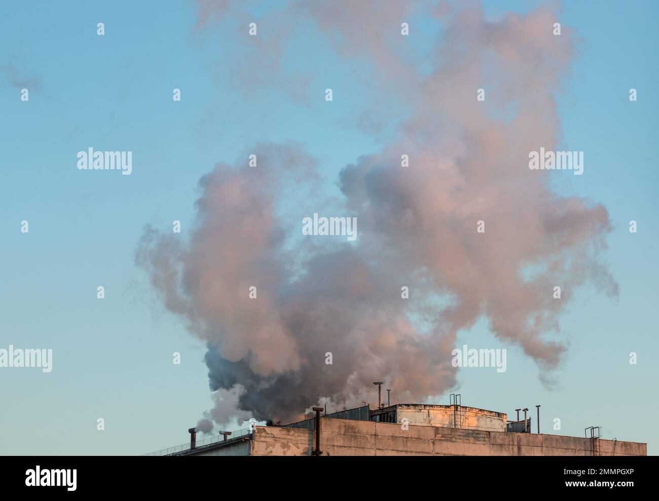 Brick chimney with white smoke over an industrial building Stock Photo ...