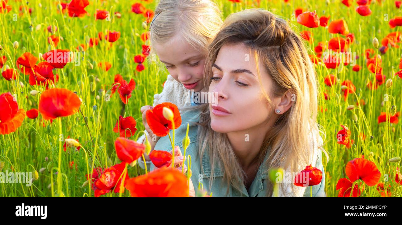 Mother and daughter on the poppies field background. Spring family ...