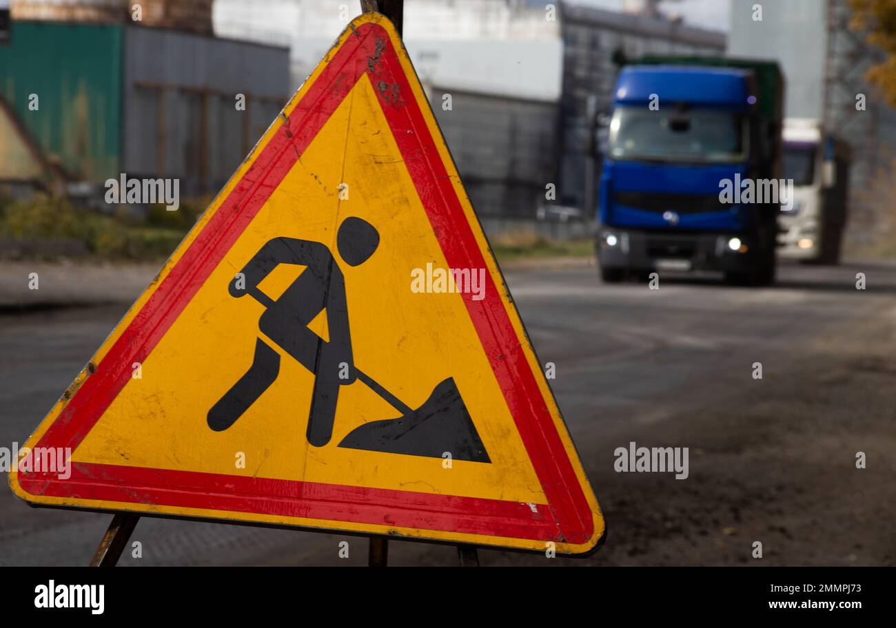 Roadworks Warning Sign Ahead On Street Sidewalk Close up Stock Photo roadworks-warning-sign-ahead-on-street-sidewalk-close-up-stock-photo
