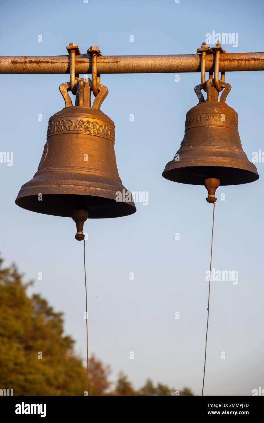Large Church bell hanging outside. Close-up view of metal orthodox ...