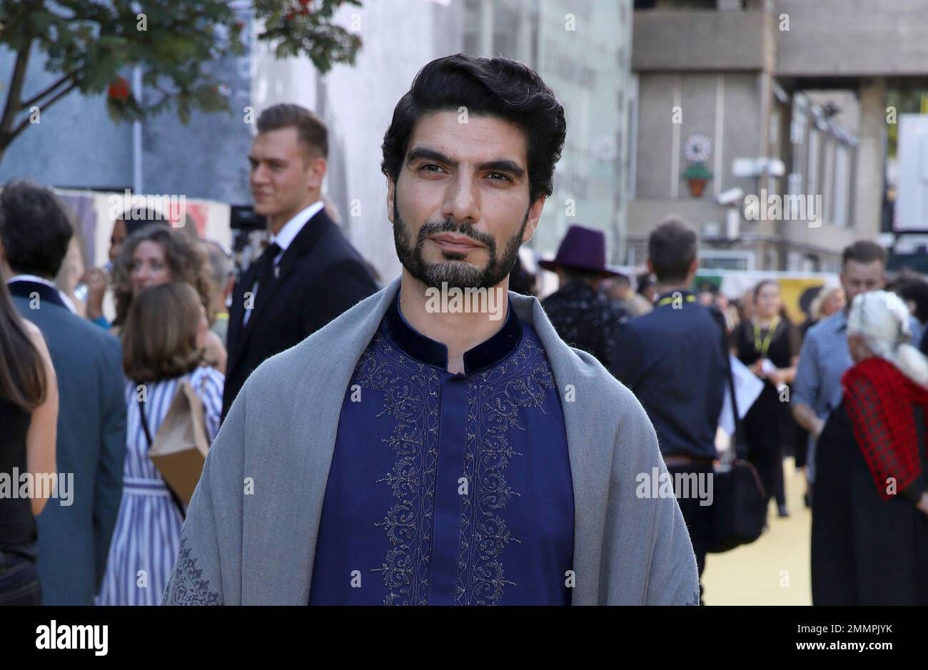 Actor Akin Gazi poses for photographers on arrival at the premiere of ...