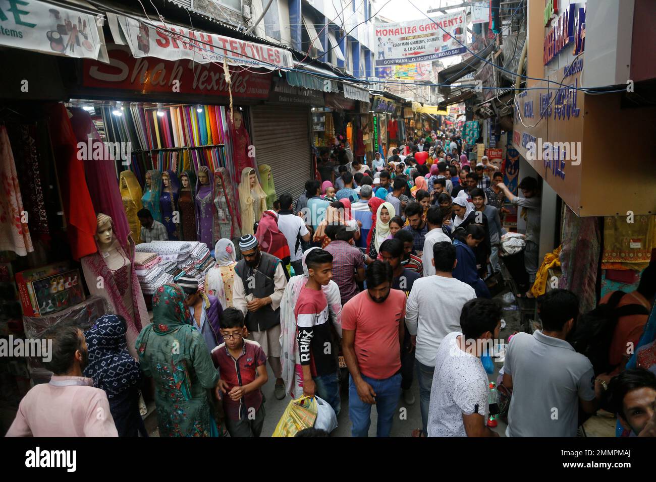 Kashmiris shop at a local market ahead of Eid al-Adha festival in ...