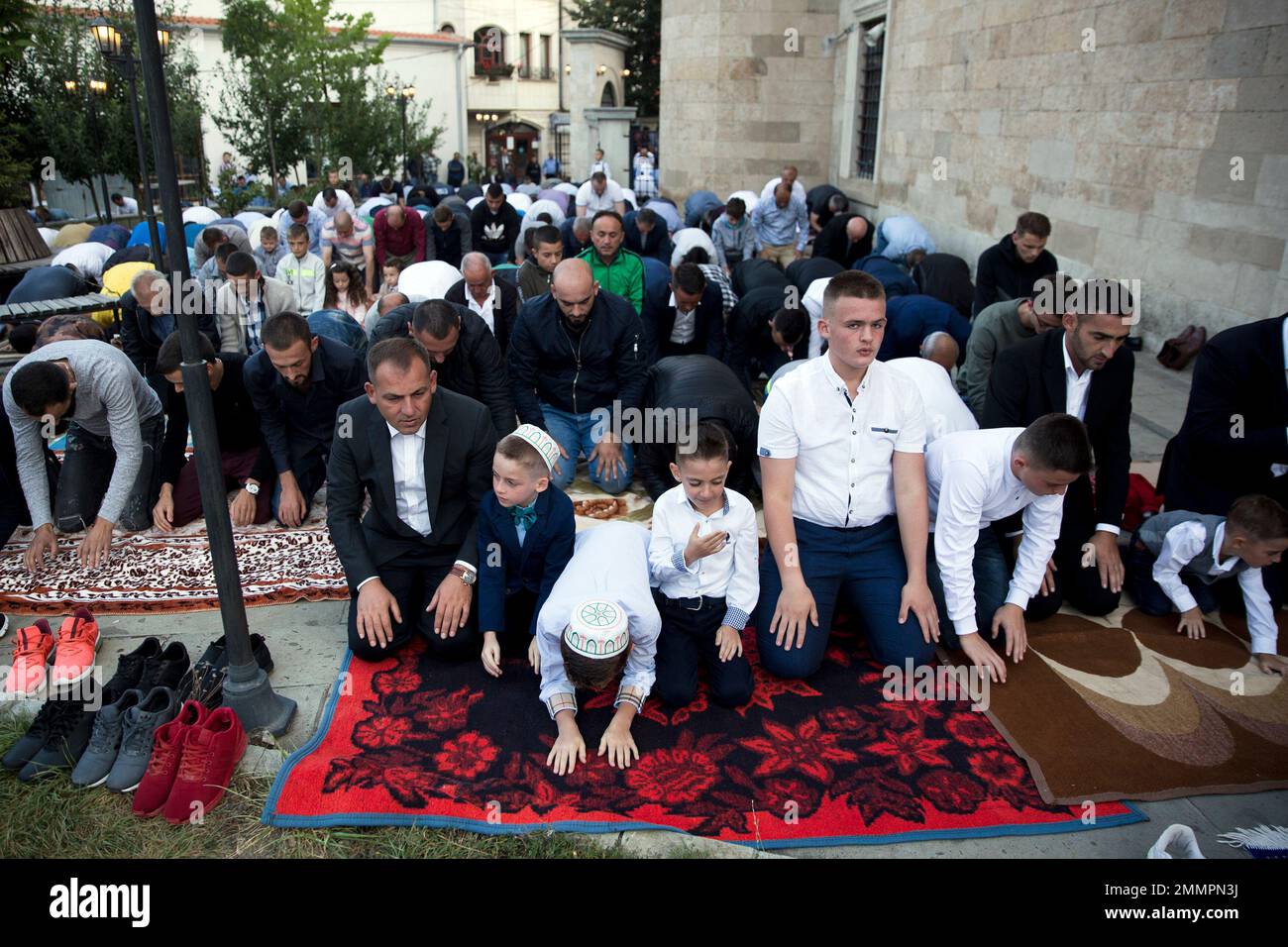 Kosovo men pray to mark the first day of Eid al-Adha outside the Sultan Mehmet Fatih mosque in ...