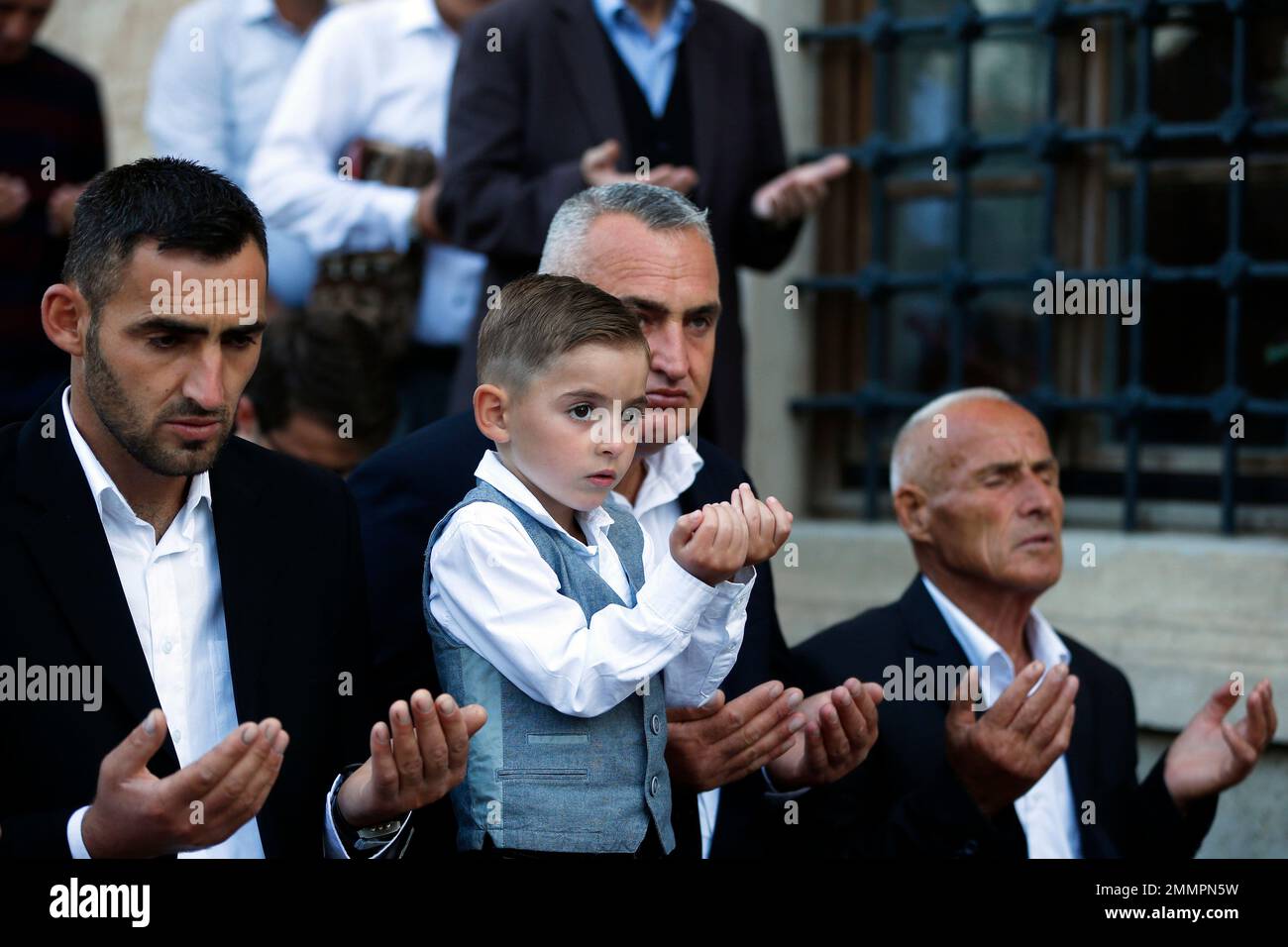Kosovo men pray to mark the first day of Eid al-Adha outside the Sultan Mehmet Fatih mosque in ...