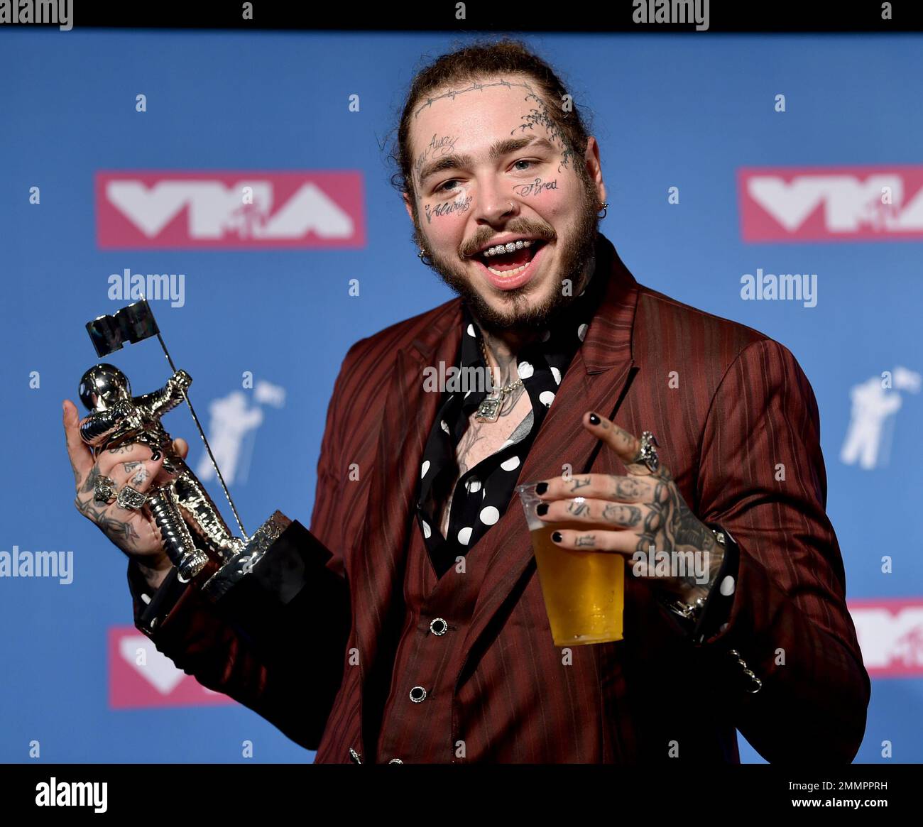 Post Malone poses with the award for song of the year for "Rockstar" in ...