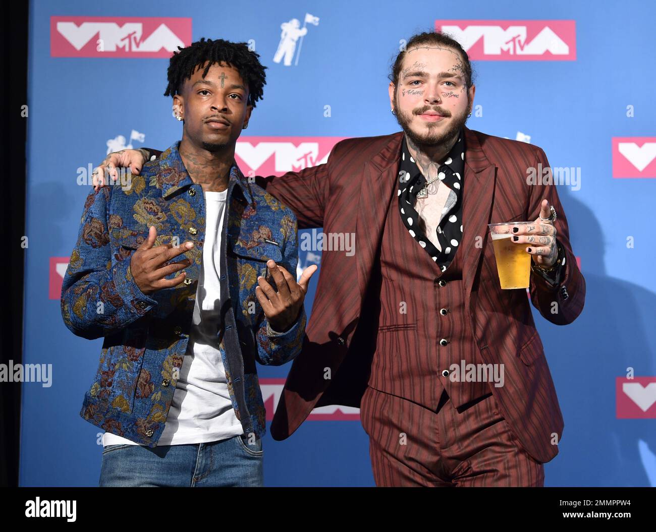 21 Savage, left, and Post Malone pose with their award for song of the ...