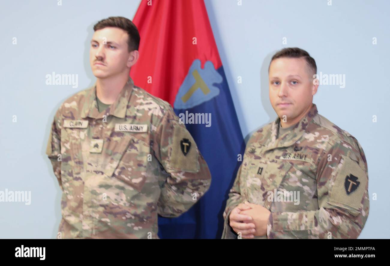 U.S. Army Capt. Cory Finn (right), commander of Headquarters and ...