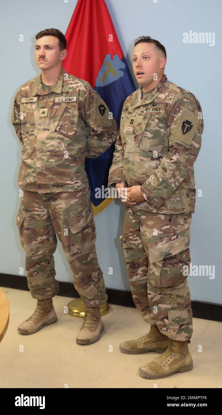 U.S. Army Capt. Cory Finn (right), commander of Headquarters and ...