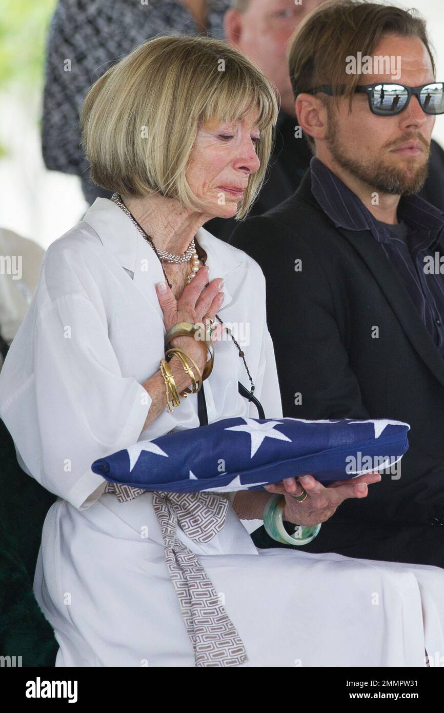 Brenda Smiley holds the American flag during a service for her husband ...
