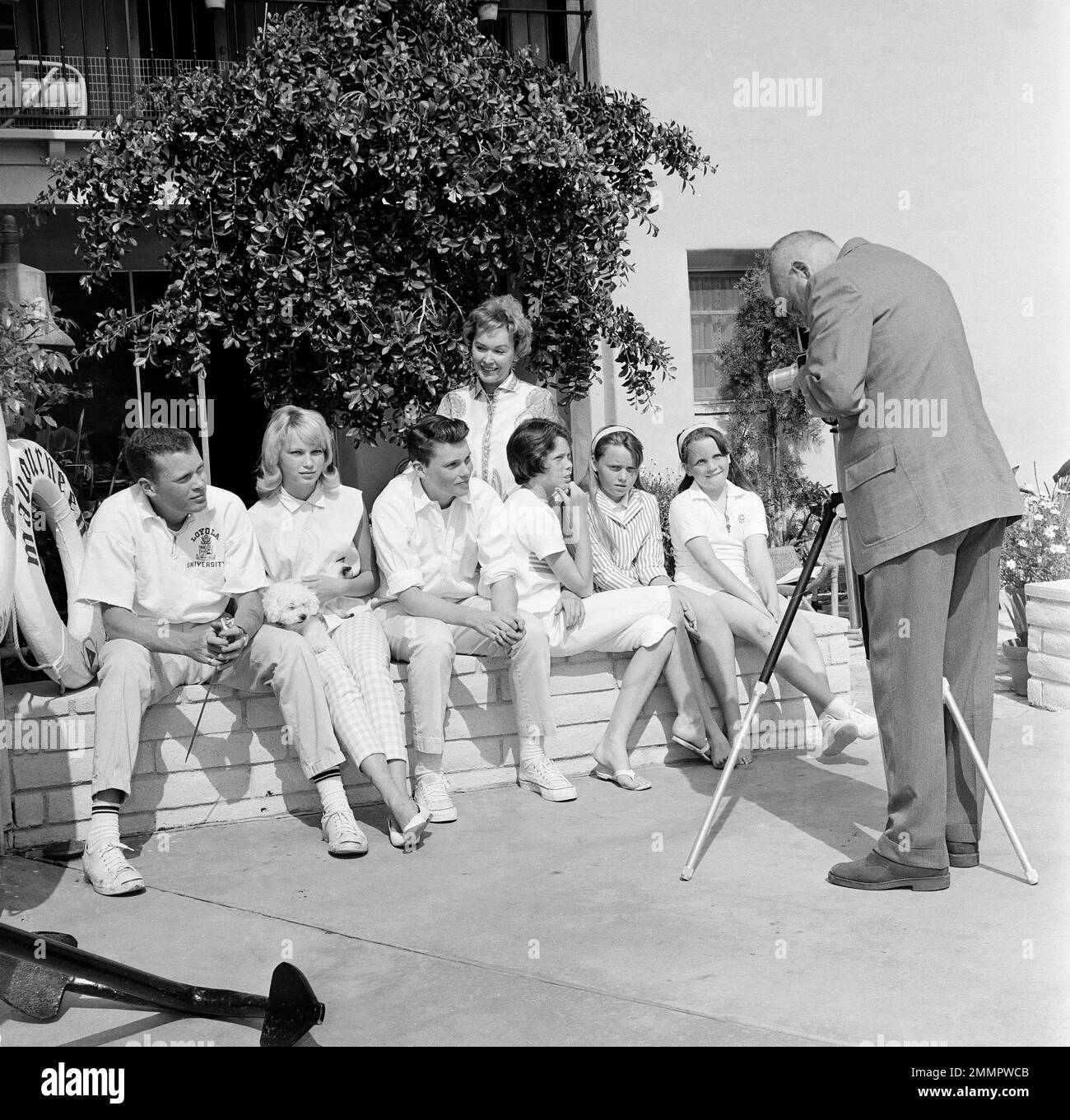 The Farrow family sits down for a group photo in front of their home in ...