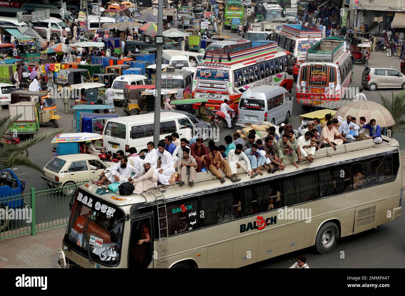 People ride on a crowded passenger bus to reach their villages and ...
