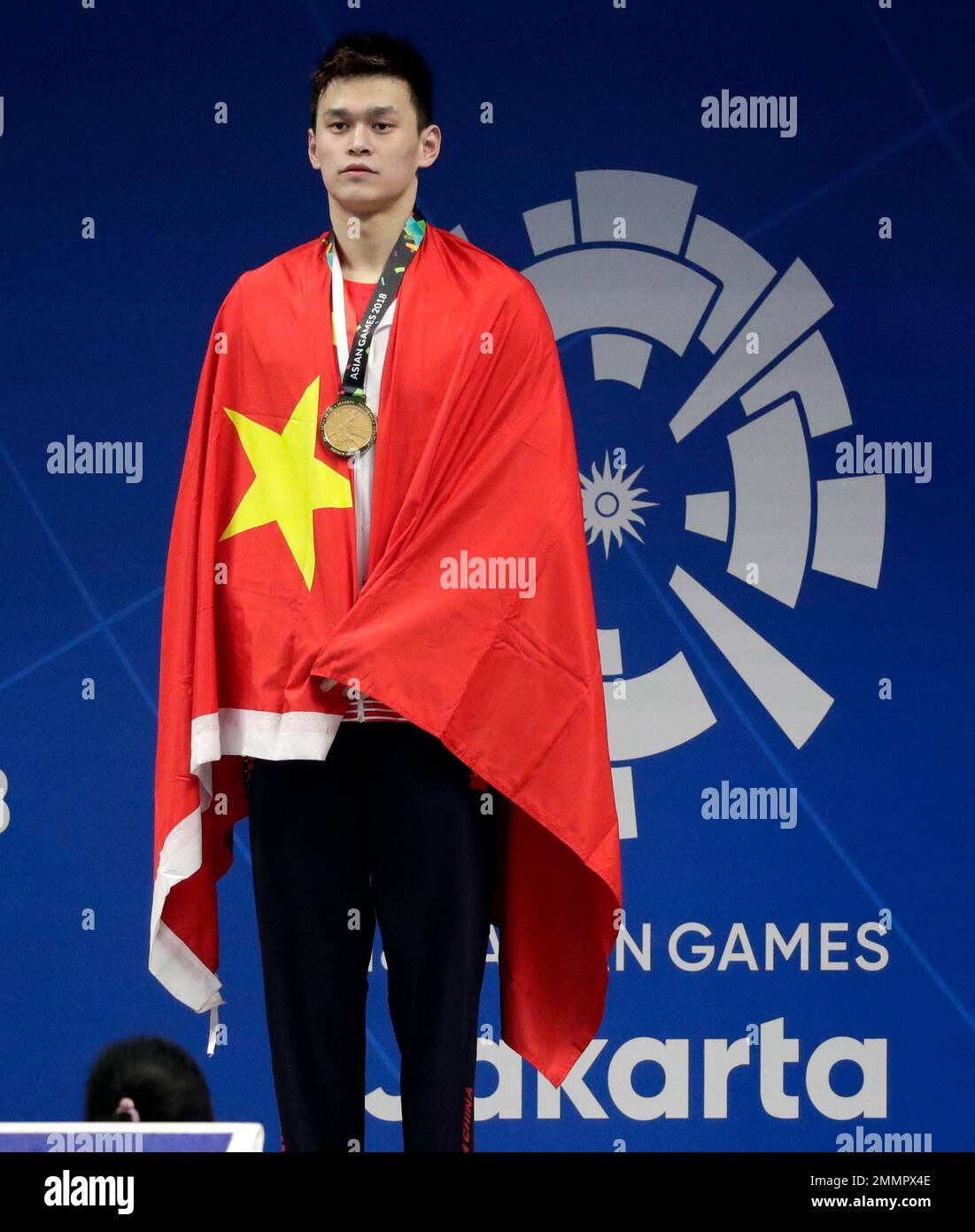 China's Sun Yang stands on the podium after winning the gold medal in ...