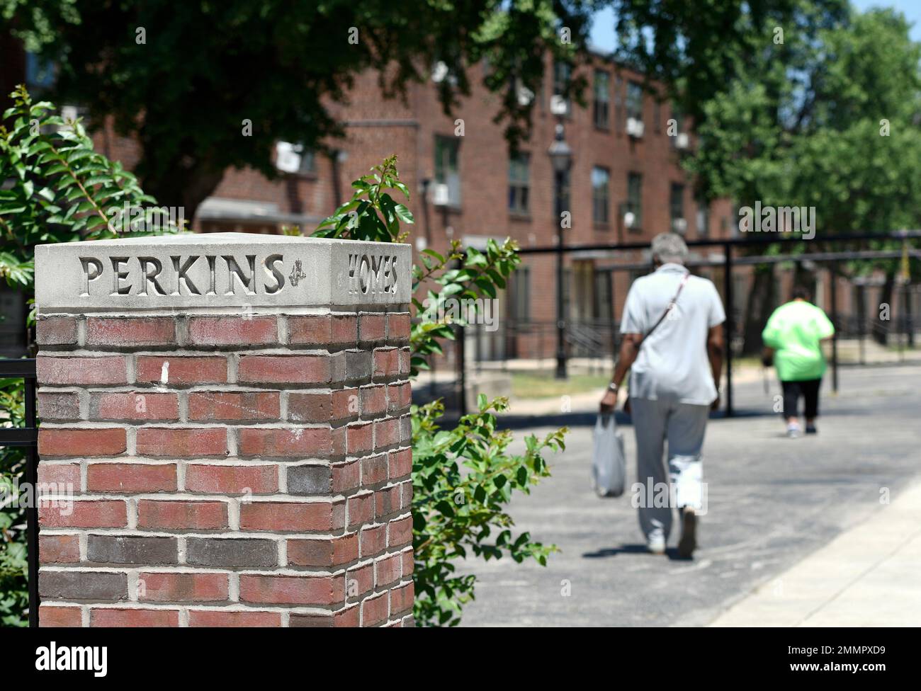 Residents walk through a courtyard at the Perkins Homes public housing ...