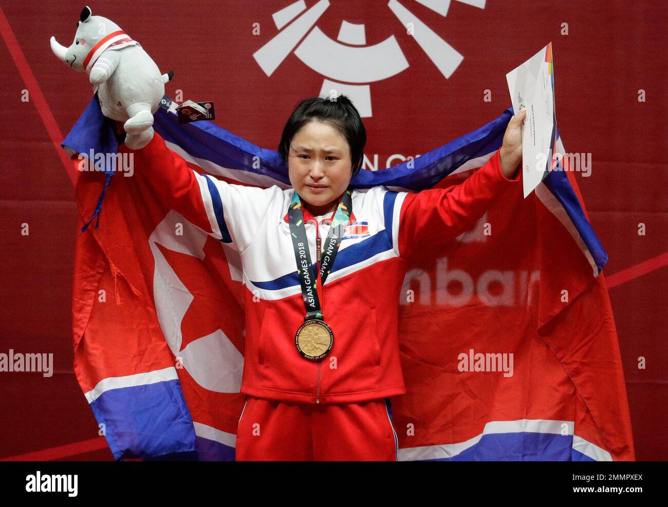 North Korean Ri Song Gum is teary eyed as she waves her national flag ...