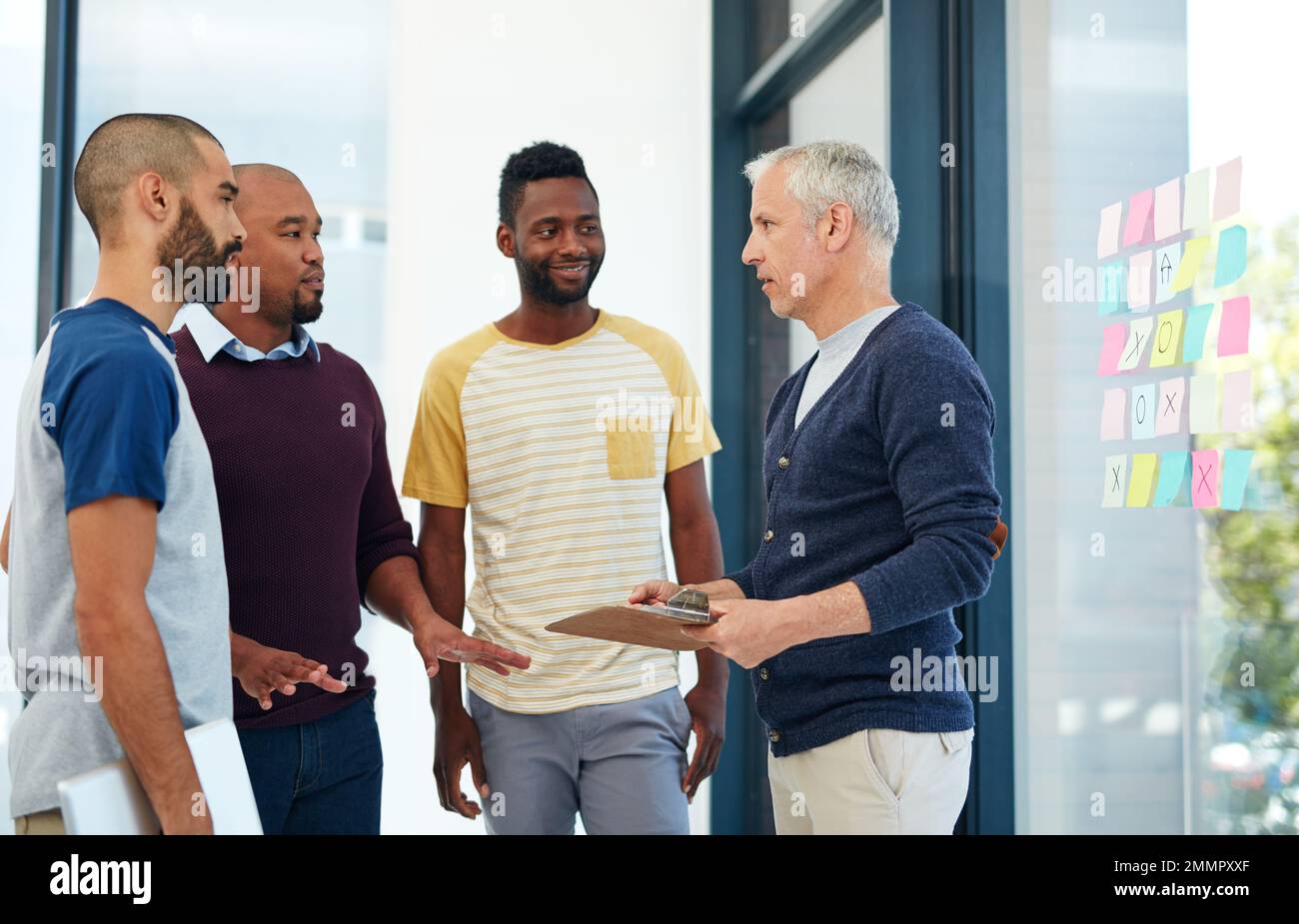 Sharing some ideas with his team. a group of creative colleagues ...