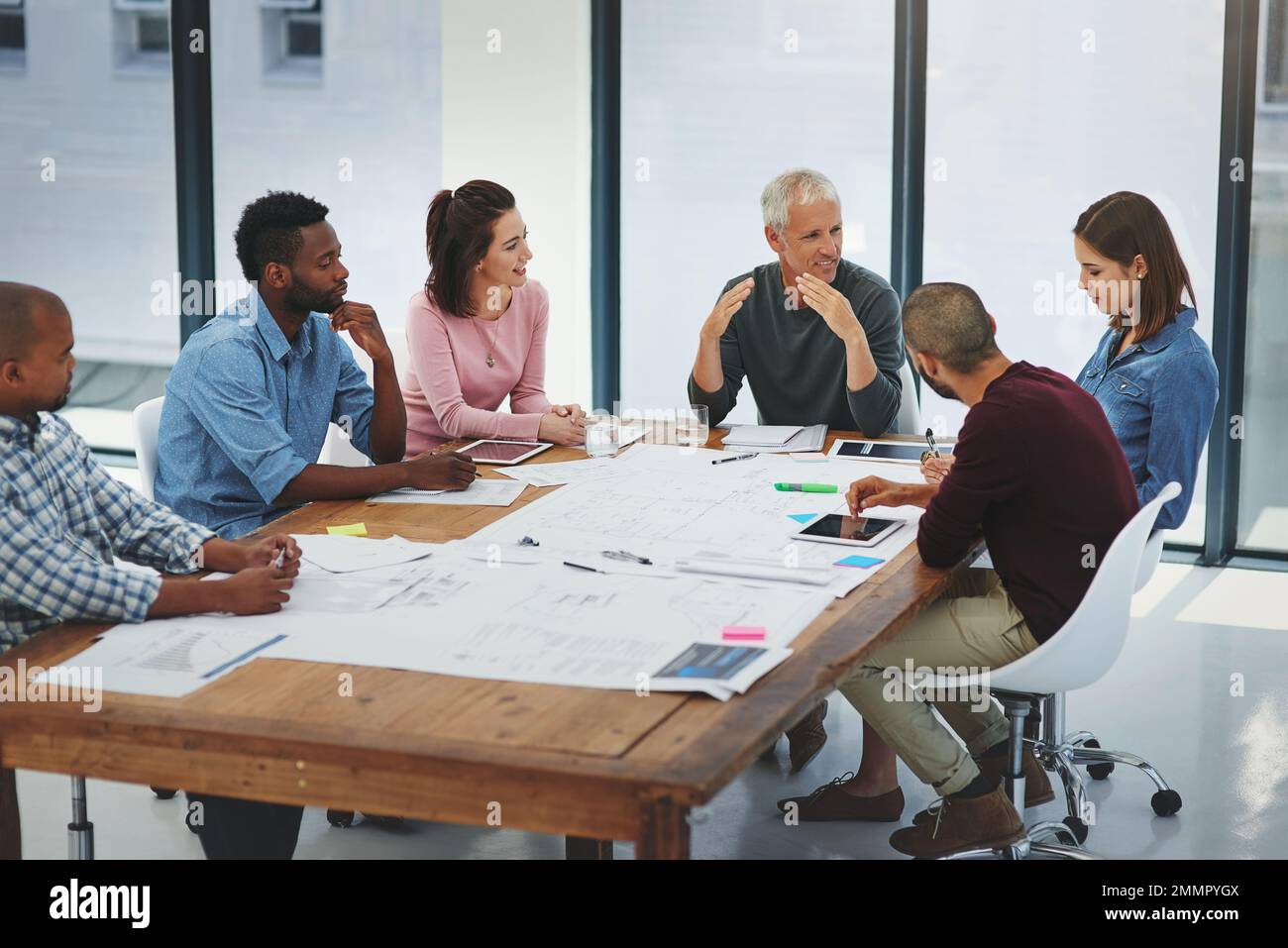 The designated design team. a group of architects looking over ...
