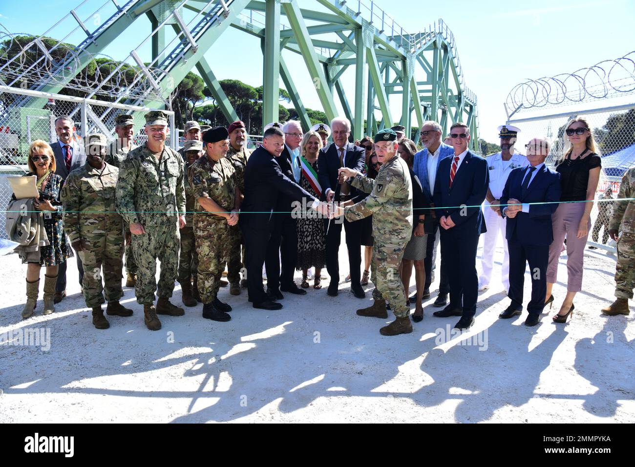 Center, the ribbon cutting is performed, from right to left, U.S. Army ...