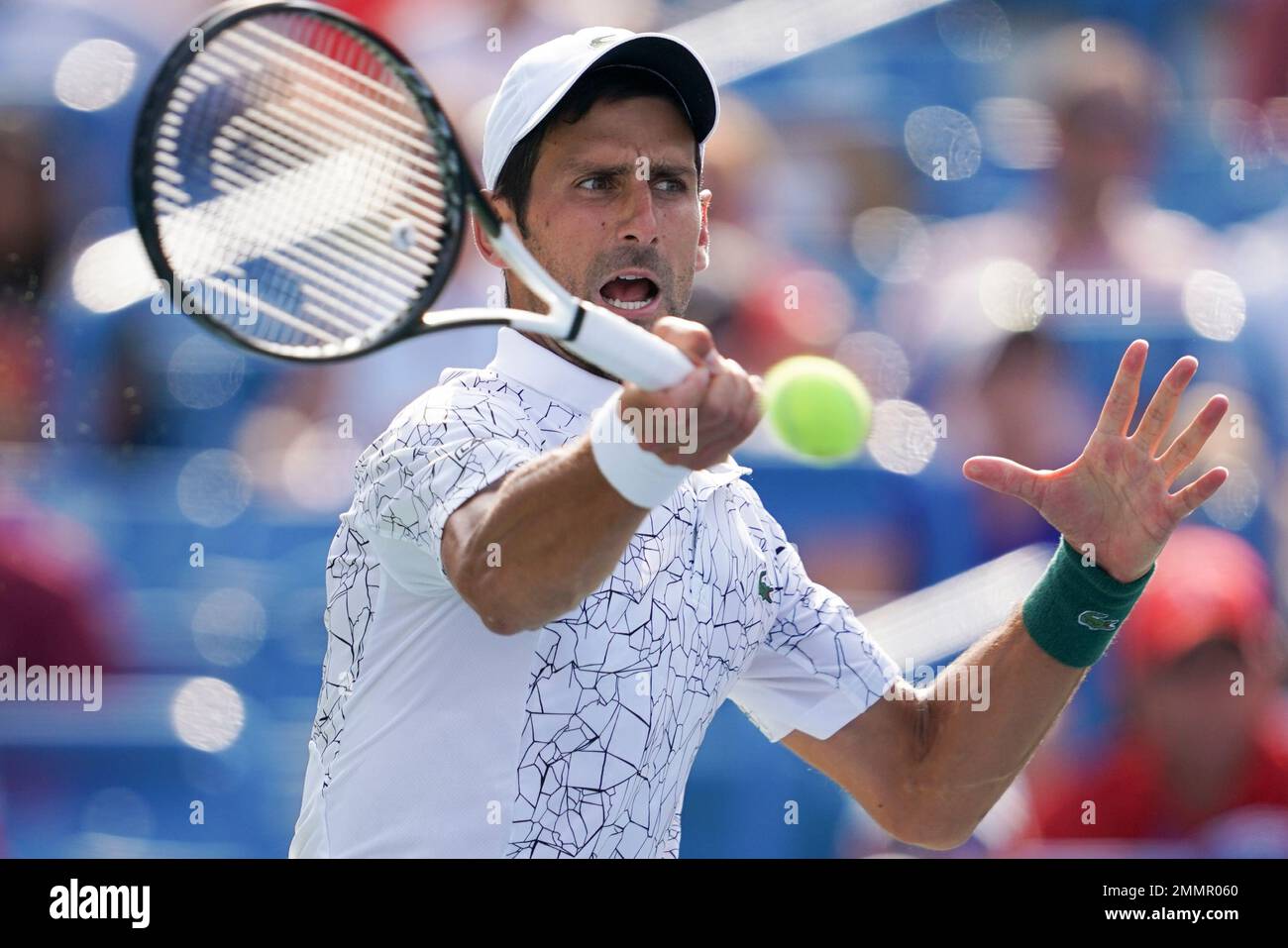 Novak Djokovic, of Serbia, returns to Roger Federer, of Switzerland ...