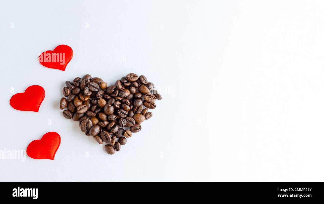Symbol of love for coffee. Heart shape made from coffee beans and red ...