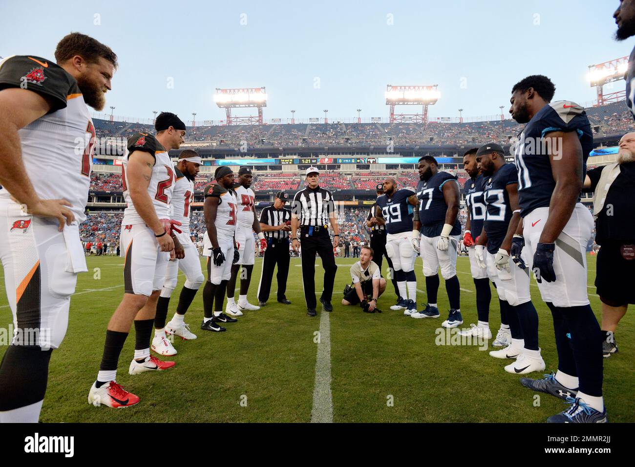 Players from the Tampa Bay Buccaneers, left, and the Tennessee Titans ...