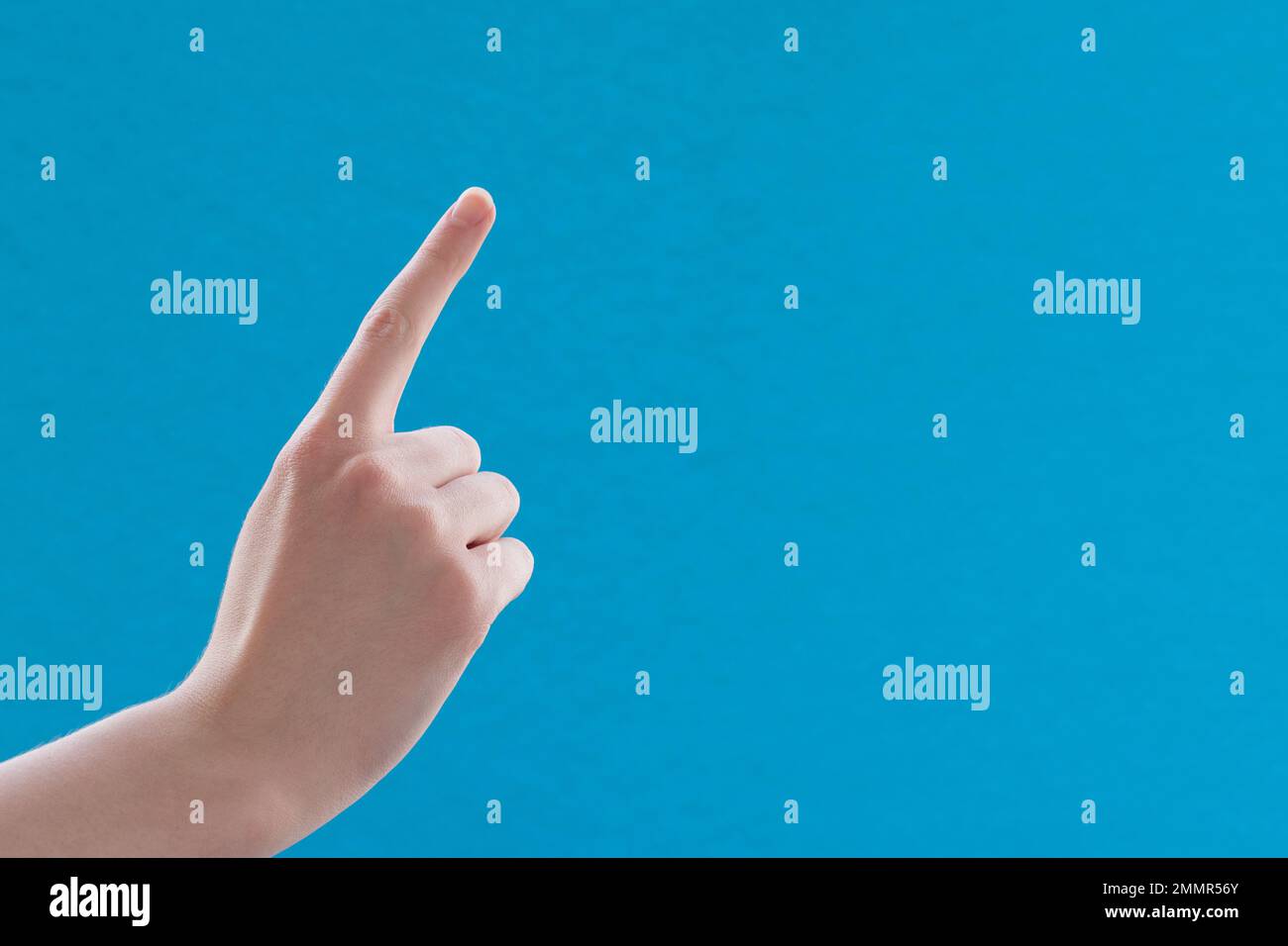 Caucasian white female hand with forefinger raised up and pointing, on ...