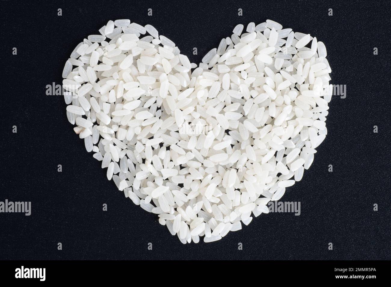 Diet food concept. Love for rice. Heart shaped uncooked rice isolated ...