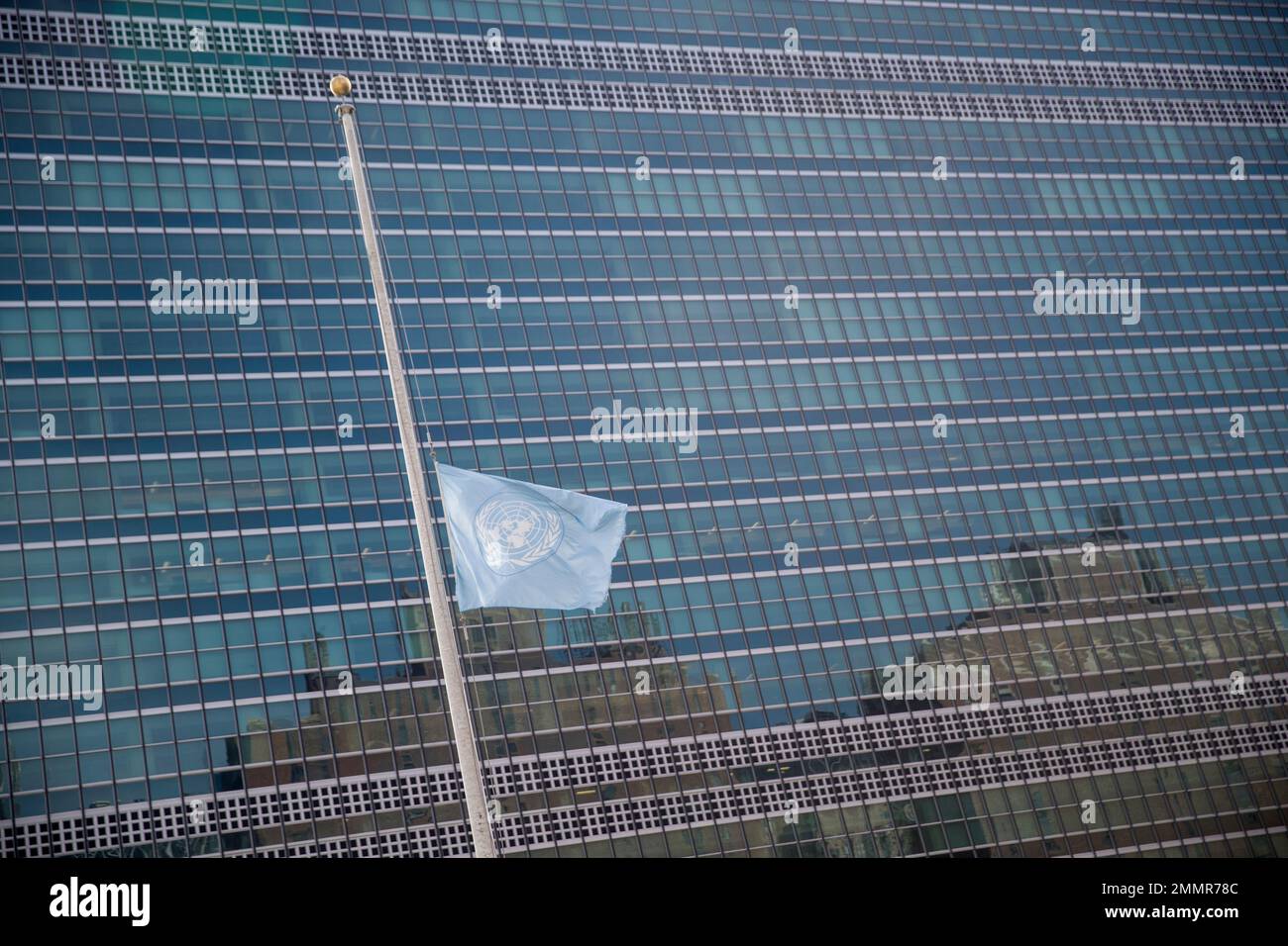 The United Nations flag flies at half staff in honor of former ...