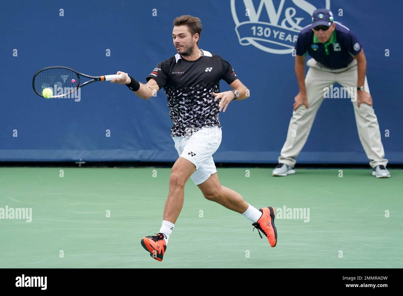 Stan Wawrinka, of Switzerland, returns to Marton Fucsovics, of Hungary ...