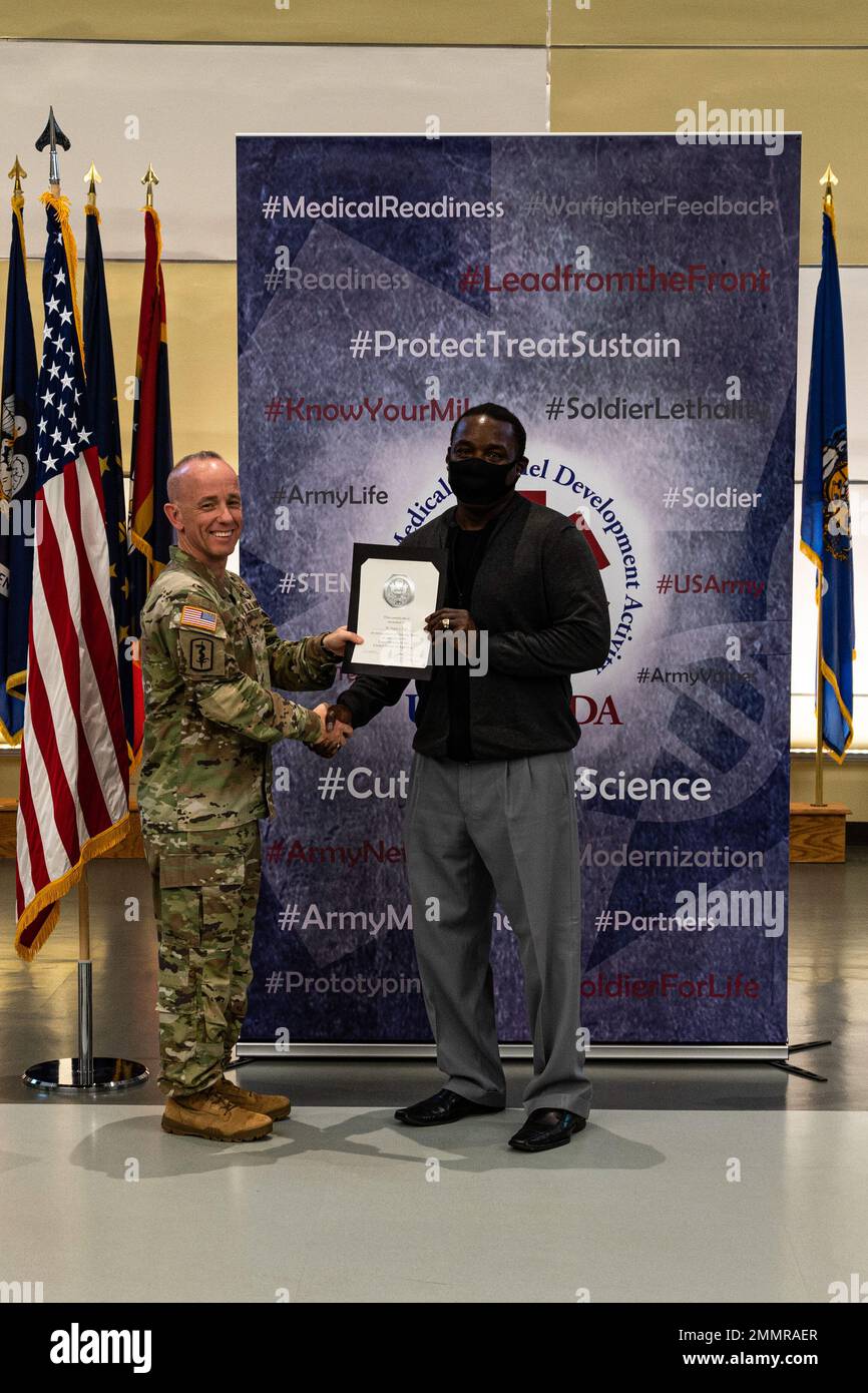 Col. Andy Nuce presents Gregory Pugh a 20 year Service Award ...