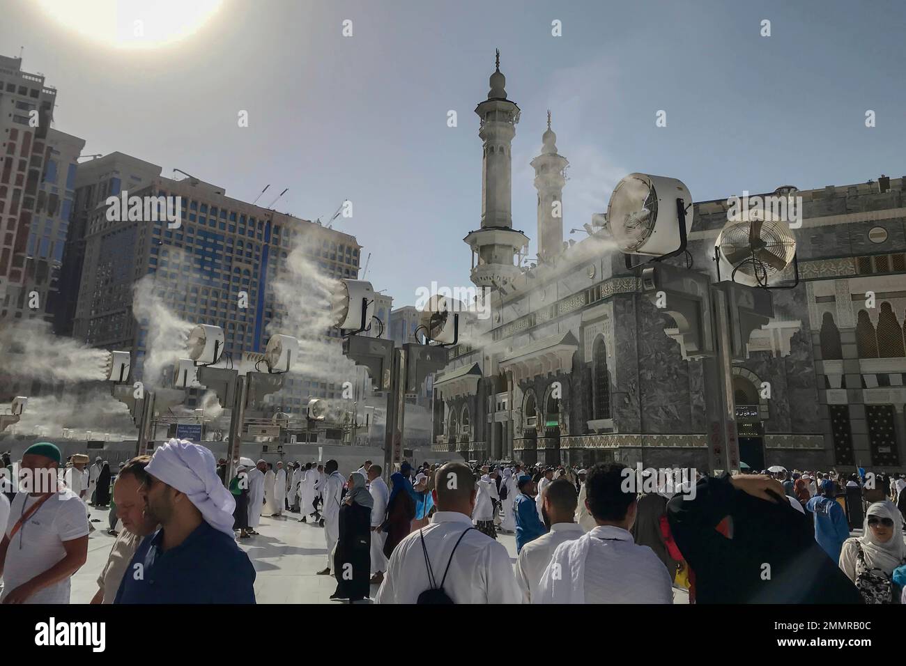 Large cooling fans spray water on Muslim pilgrims around the Grand ...