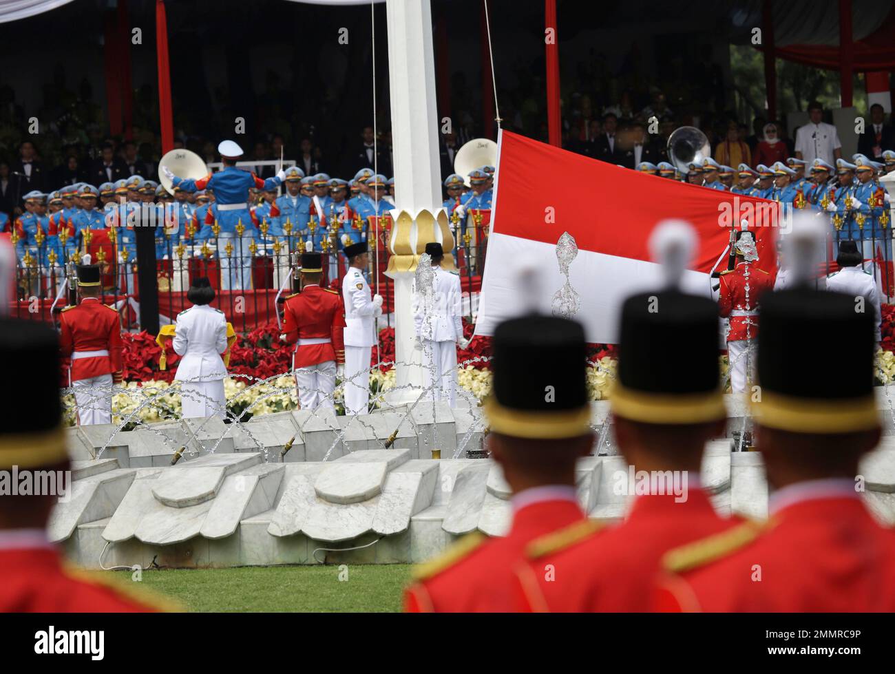 Flag bearers hoist an Indonesian national red and white flag during a ...