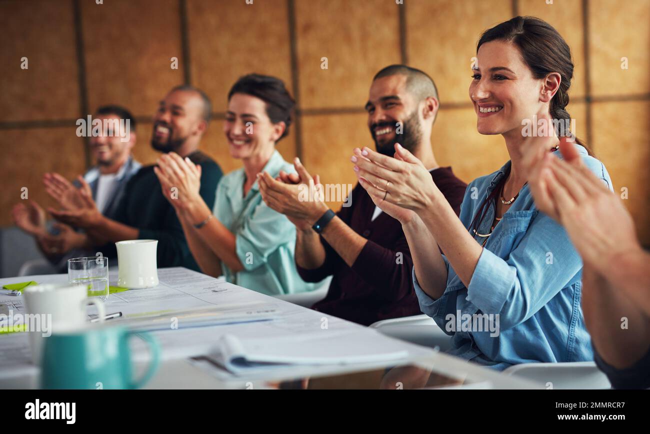The creative process. a group of colleagues clapping together at a ...