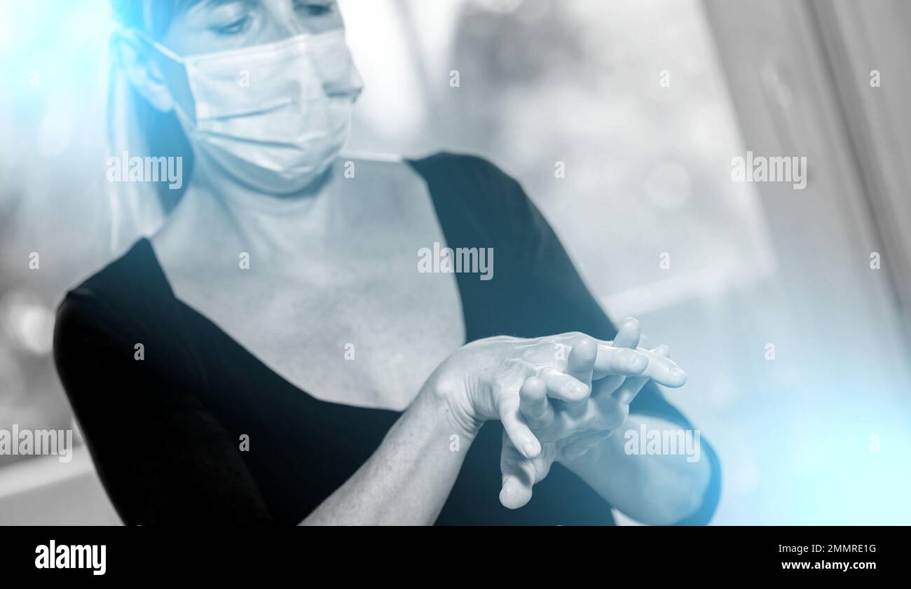 Woman rubbing her hands with sanitizer alcohol gel; prevention of virus ...