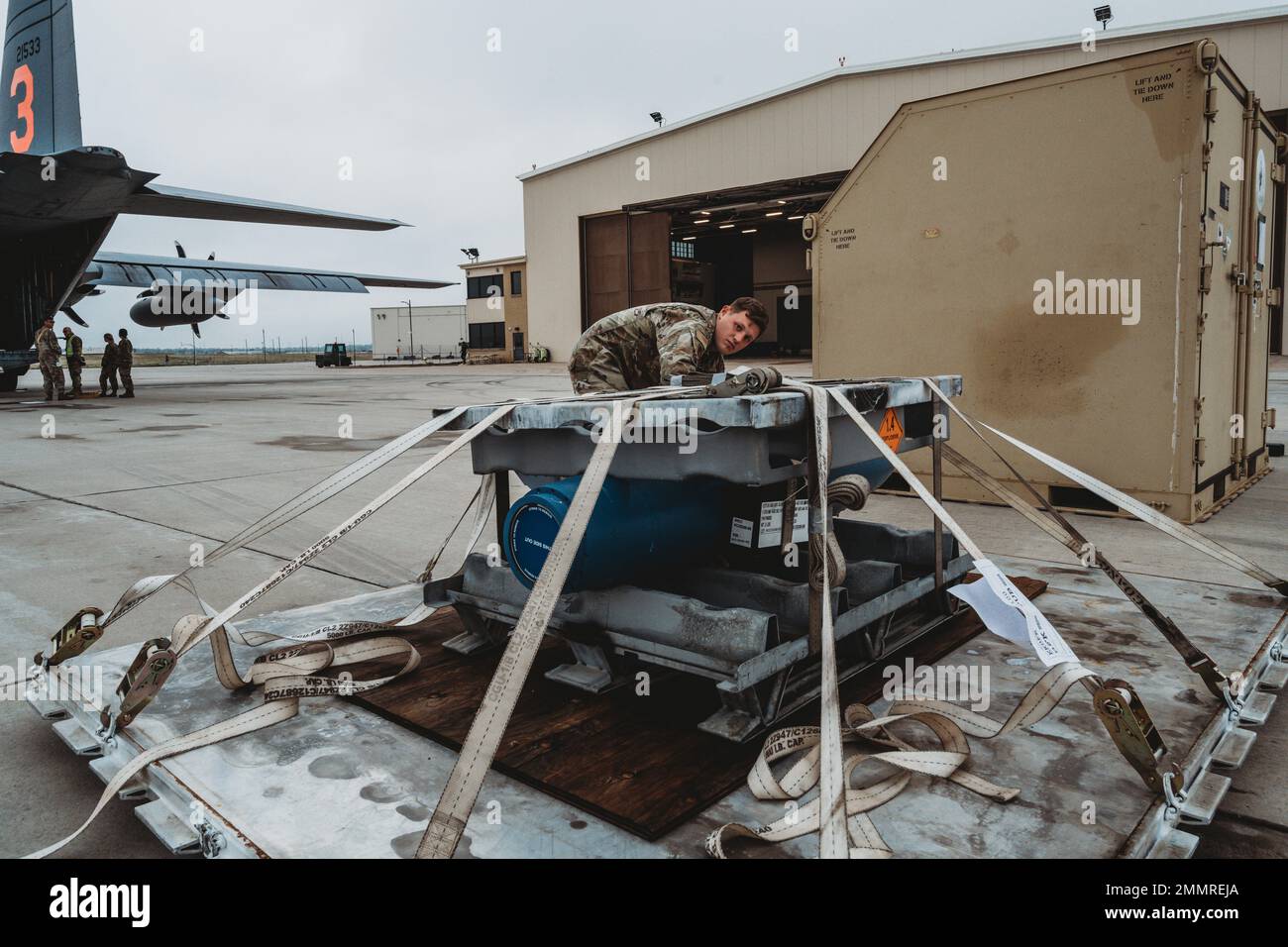 U.S. Air Force Staff Sgt. Nathan Buck, loads a C-130 Hercules at ...